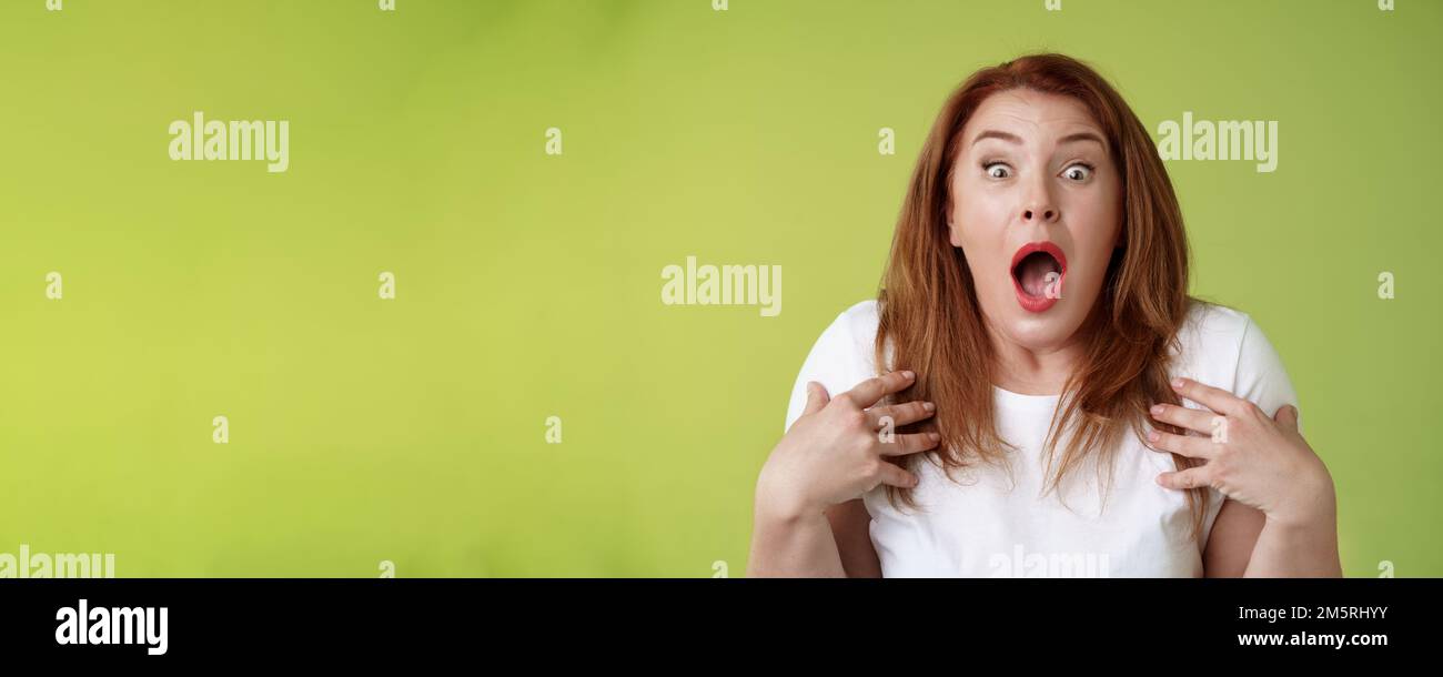 Shocked panicking redhead middle-aged woman gasping drop jaw open mouth ...