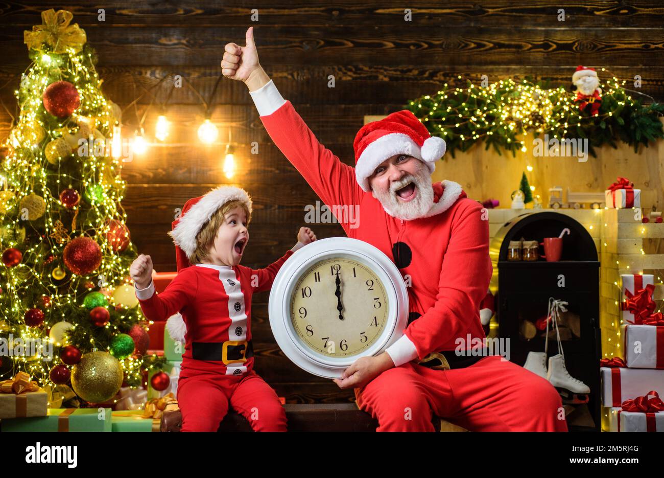 Santa Claus and little child boy with clock. Time to celebrate. New ...