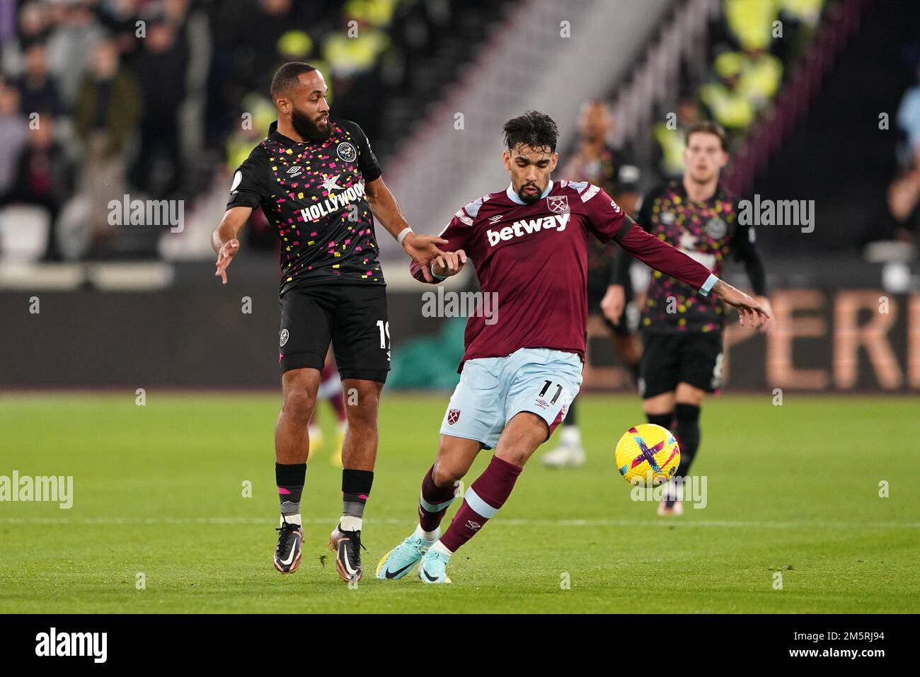 Brentford's Bryan Mbeumo (left) and West Ham United's Lucas Paqueta ...