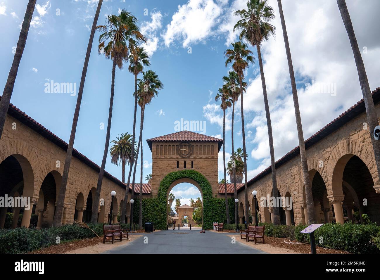 Arched built structure with ivy and clock at Stanford University campus ...