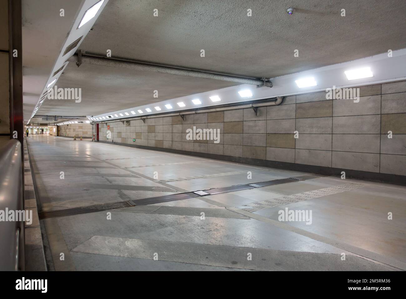 An long empty hallway with bright lights on the ceiling Stock Photo - Alamy