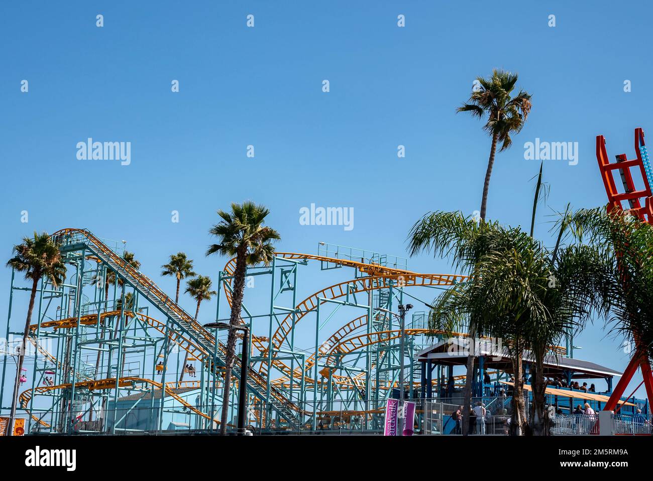 Colorful roller coaster tracks and palm trees at Santa Cruz Beach ...