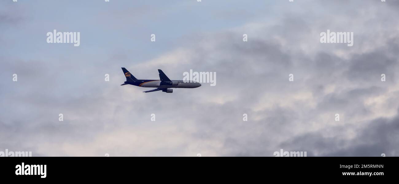 UPS Airplane flying in the sky during cloudy morning Stock Photo - Alamy