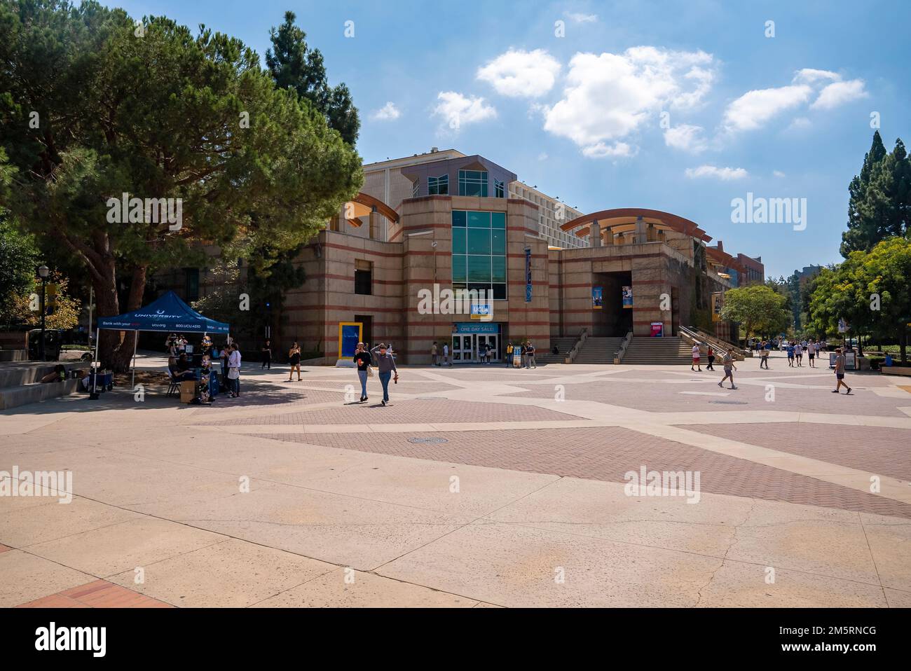 Students walking at campus in front of UCLA building during sunny day ...