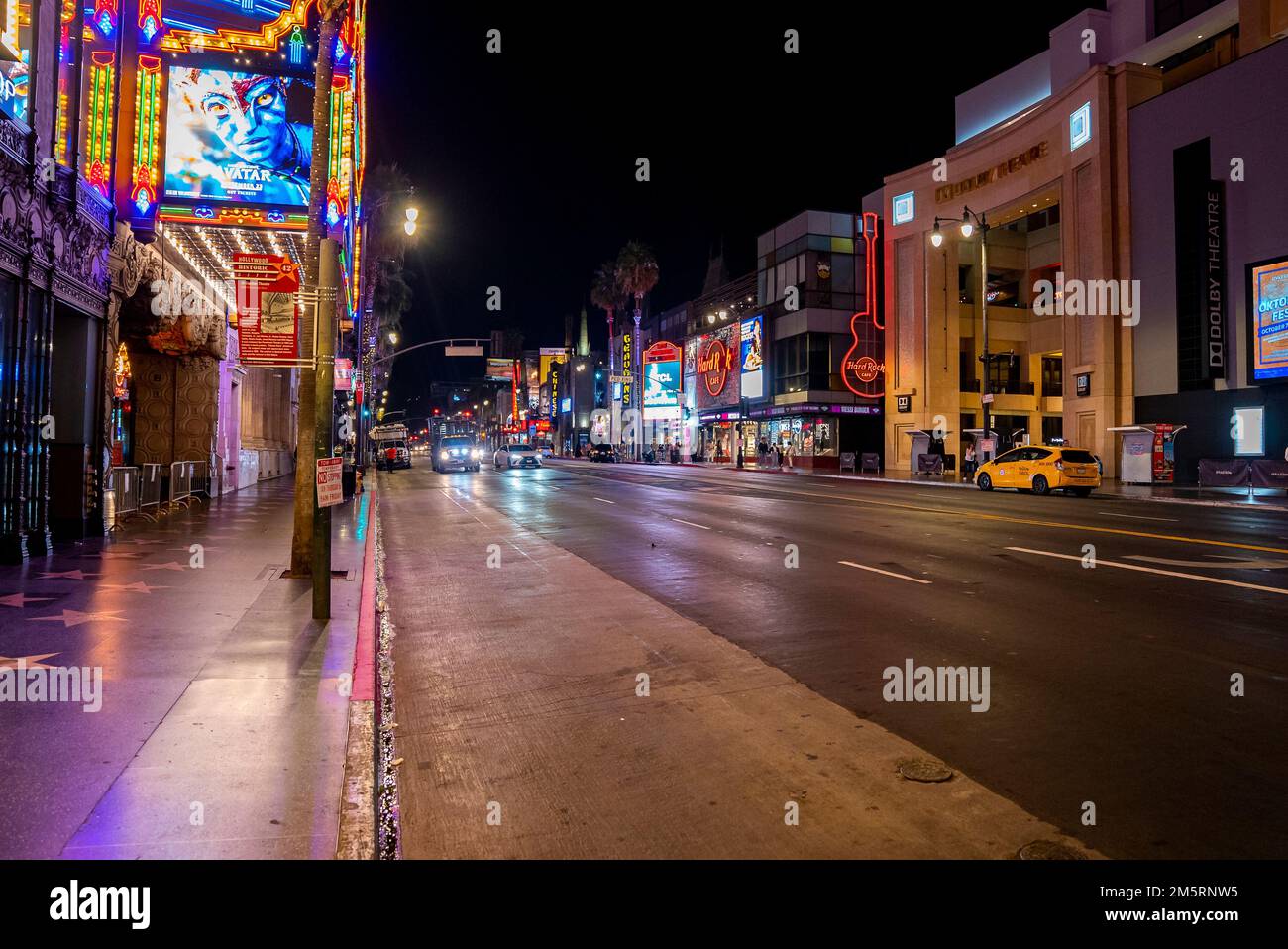 Hollywood Boulevard street amidst illuminated theatres and restaurants ...