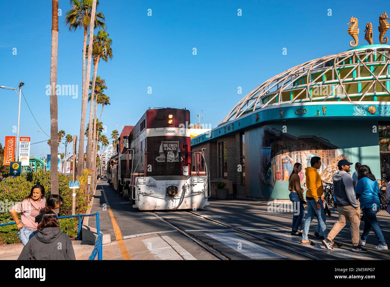 Vintage tram moving on track by building at Santa Cruz Beach Boardwalk ...