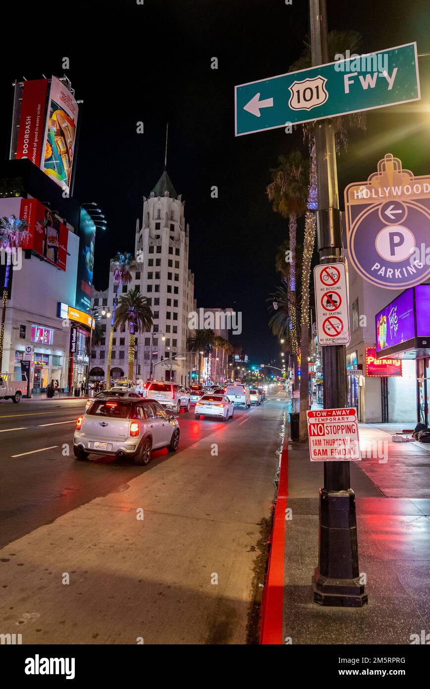 Road signs on pole and cars moving on Hollywood Boulevard street at ...