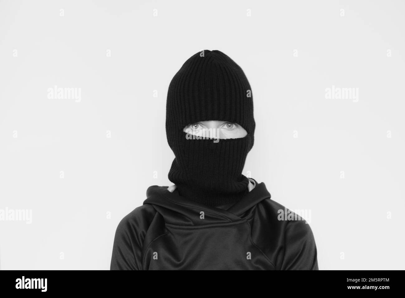 Hat balaclava on a girl on a white background, the face of a thief in ...