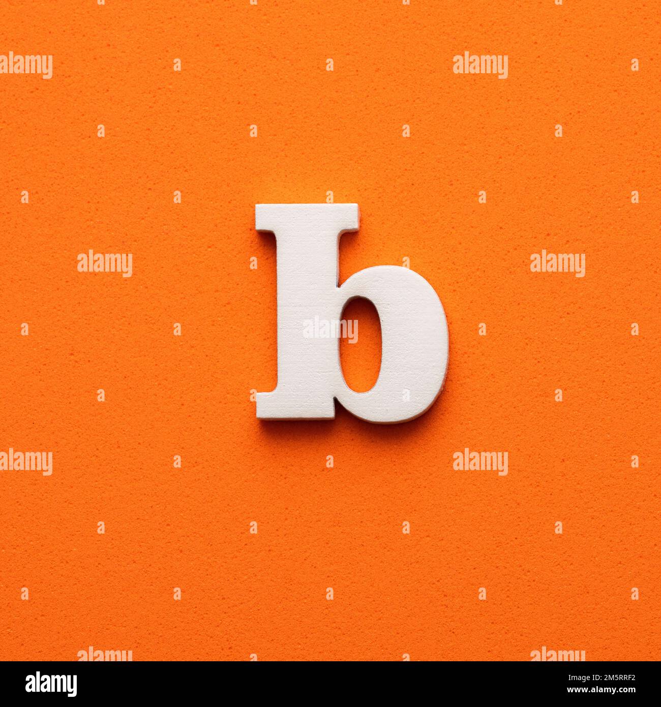 b white lowercase letter - Background in orange foamy Stock Photo - Alamy