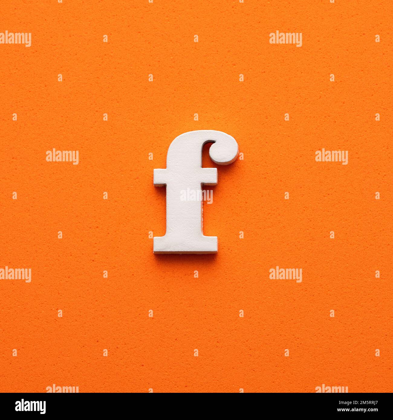 f white lowercase letter - Background in orange foamy Stock Photo - Alamy