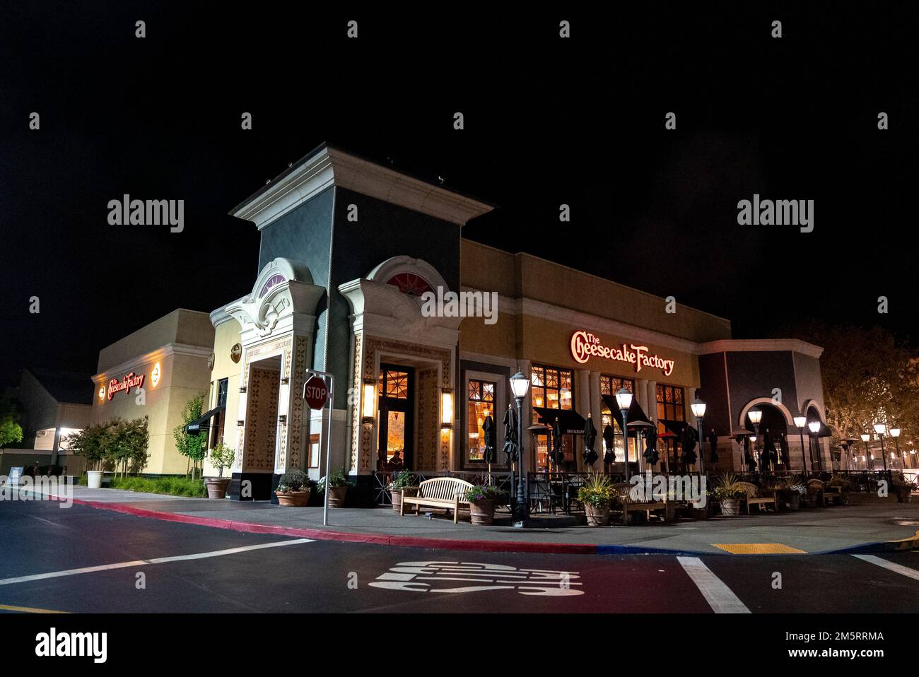 Exterior of modern restaurant with illuminated the cheesecake factory ...