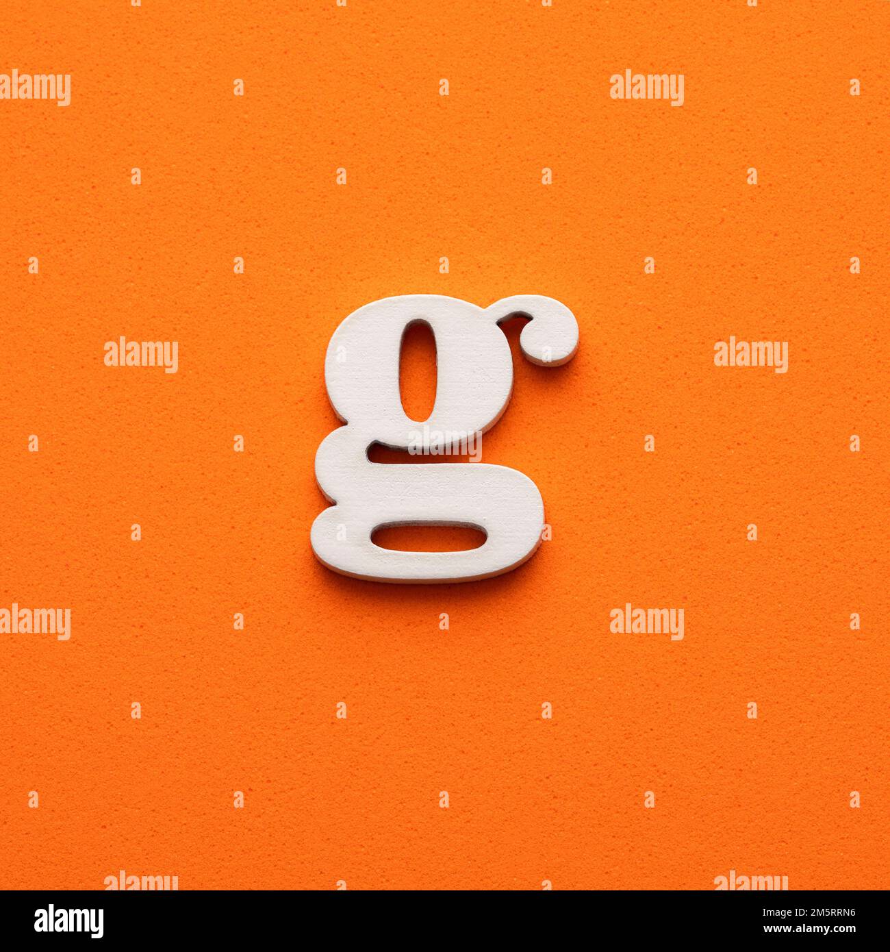 White lowercase letter g on orange foamy background Stock Photo - Alamy