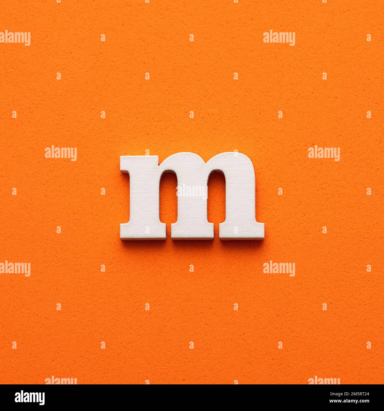White lowercase letter m on orange foamy background Stock Photo - Alamy