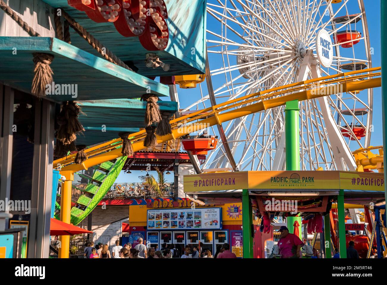 View of ferris wheel and roller coaster rides at Pacific amusement park ...