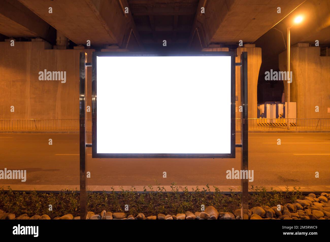 An empty white signboard on the side of a road under a bridge Stock ...