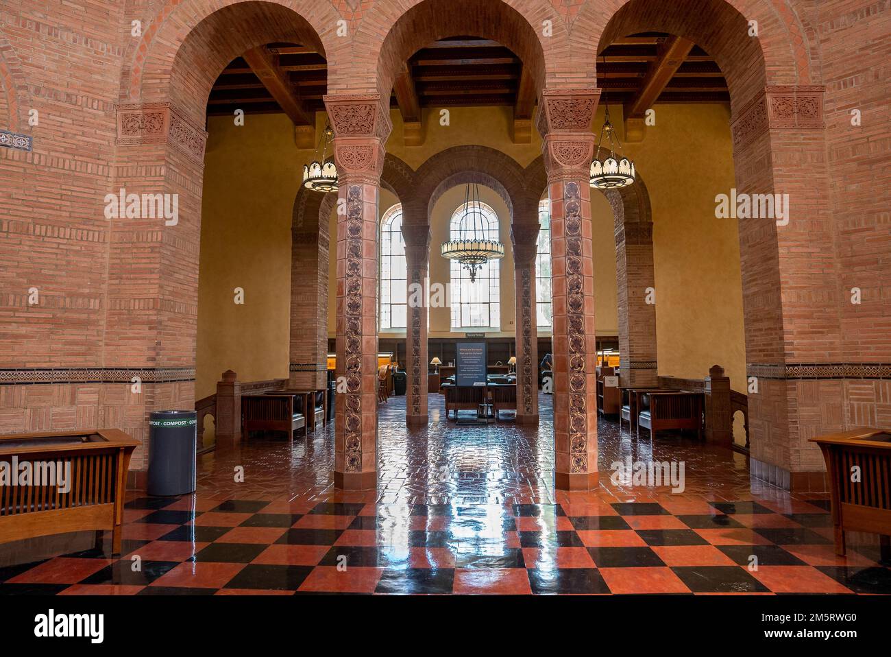 Chandeliers hanging on ceiling seen through columns and arches inside ...
