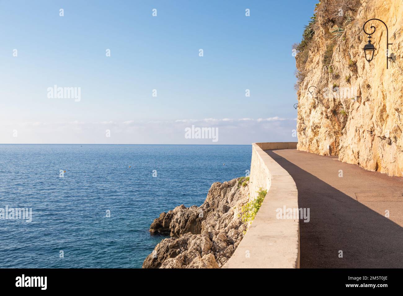 Promenade in front of the sea. Blue sky on scenery seascape. Concept of ...