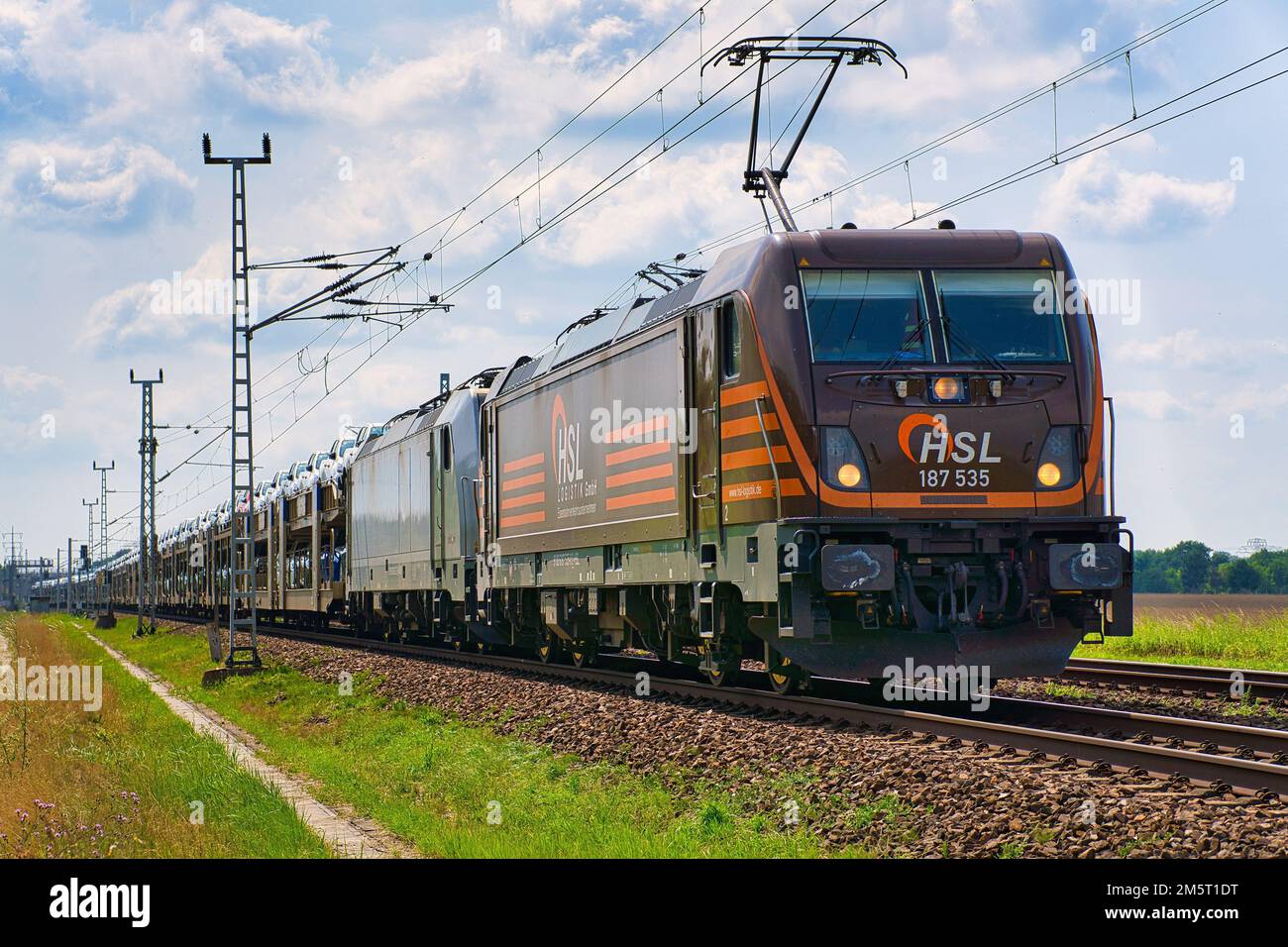 A beautiful view of a modern locomotive with a freight train during ...