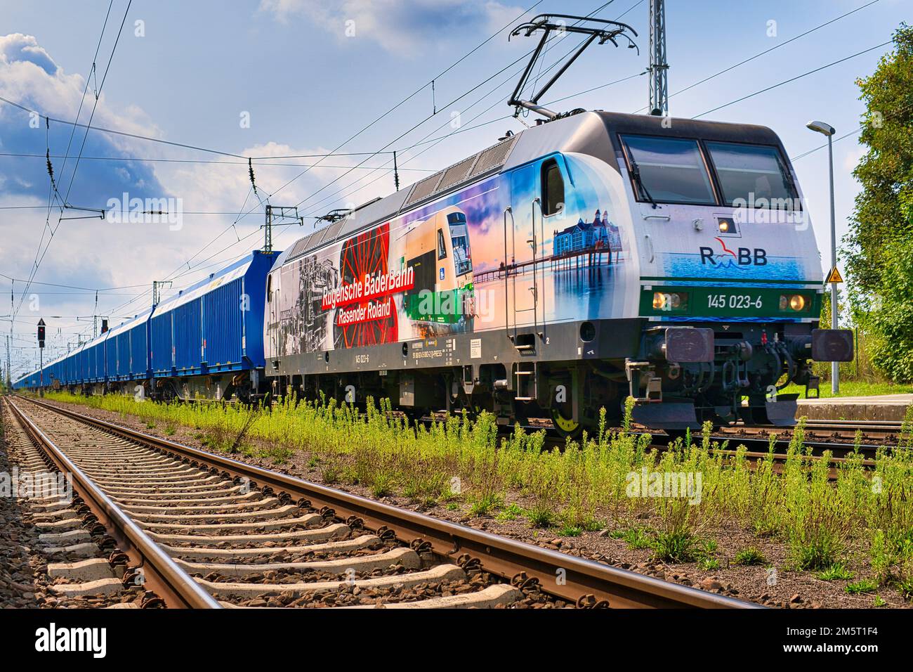 A beautiful view of a modern locomotive with a freight train during ...