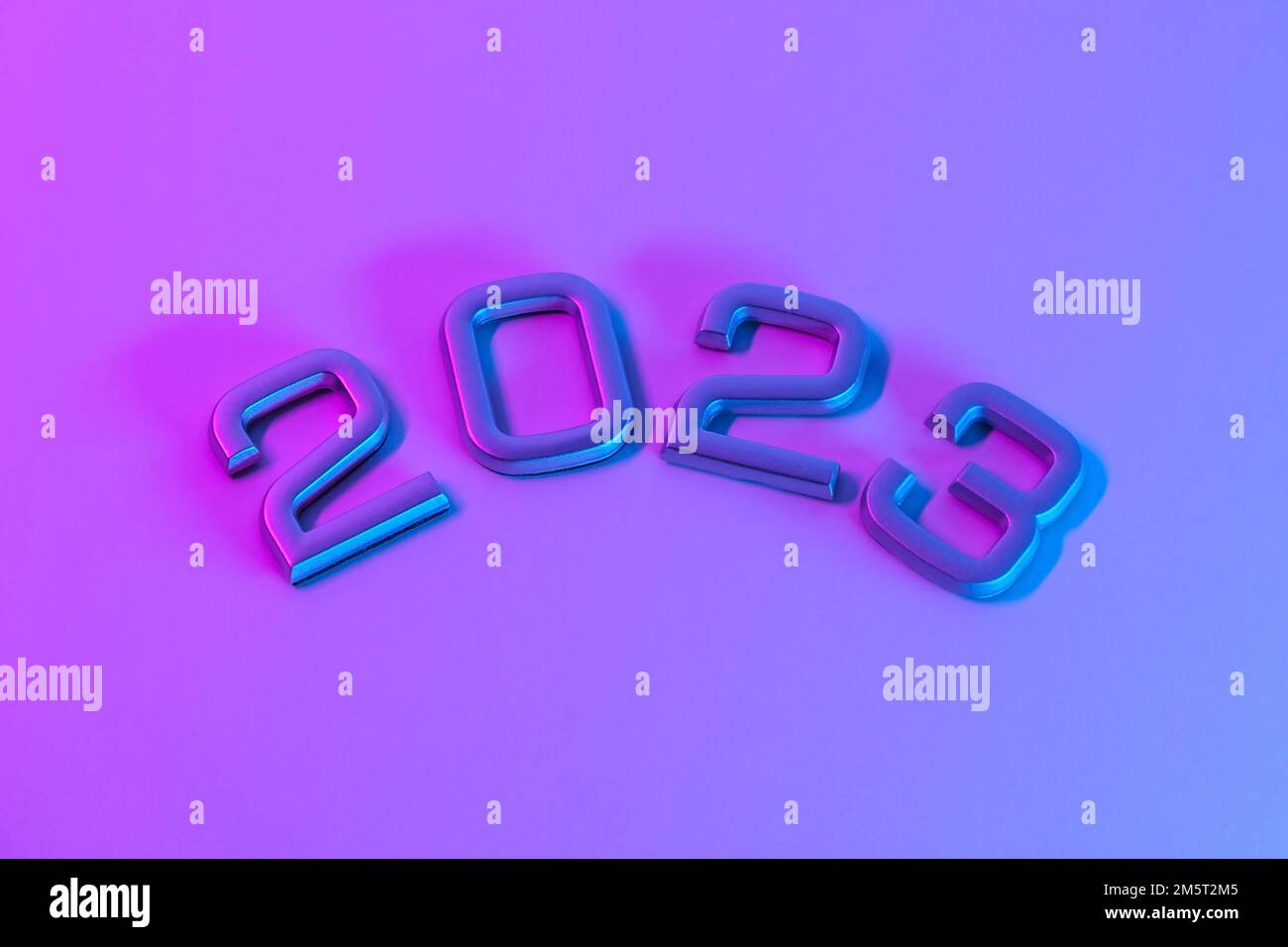 The numbers 2023 in neon light. New Year 2023 on a blue pink background ...