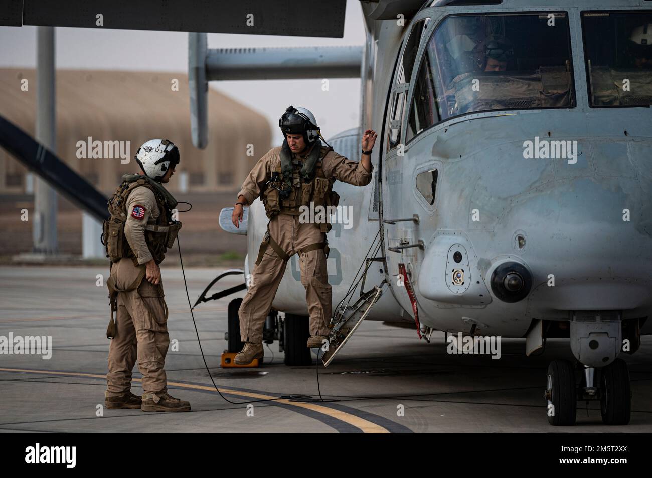Two U.S. Marine Corps MV-22 Osprey crewchiefs, assigned to Marine Medium Tiltrotor Squadron 266 ...