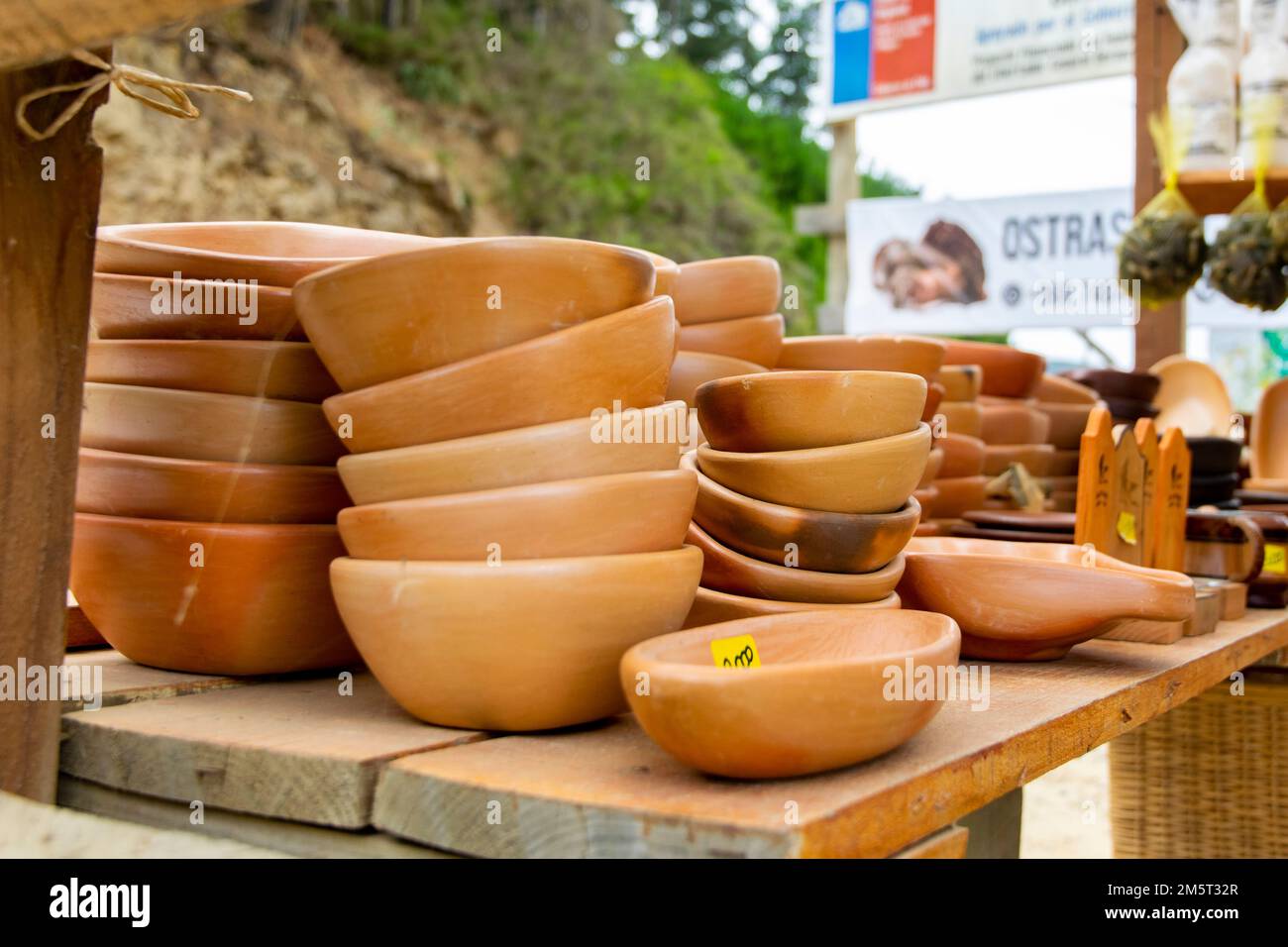 A pile of handmade clay plates in a rural shop in the road side at ...