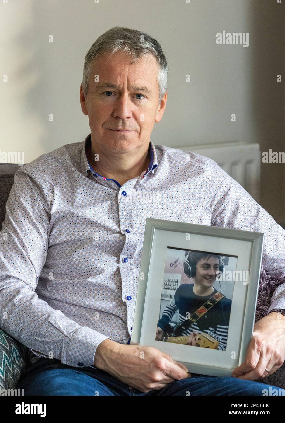 Peter Dolan holding an image of his son Enda Dolan, at his home in ...