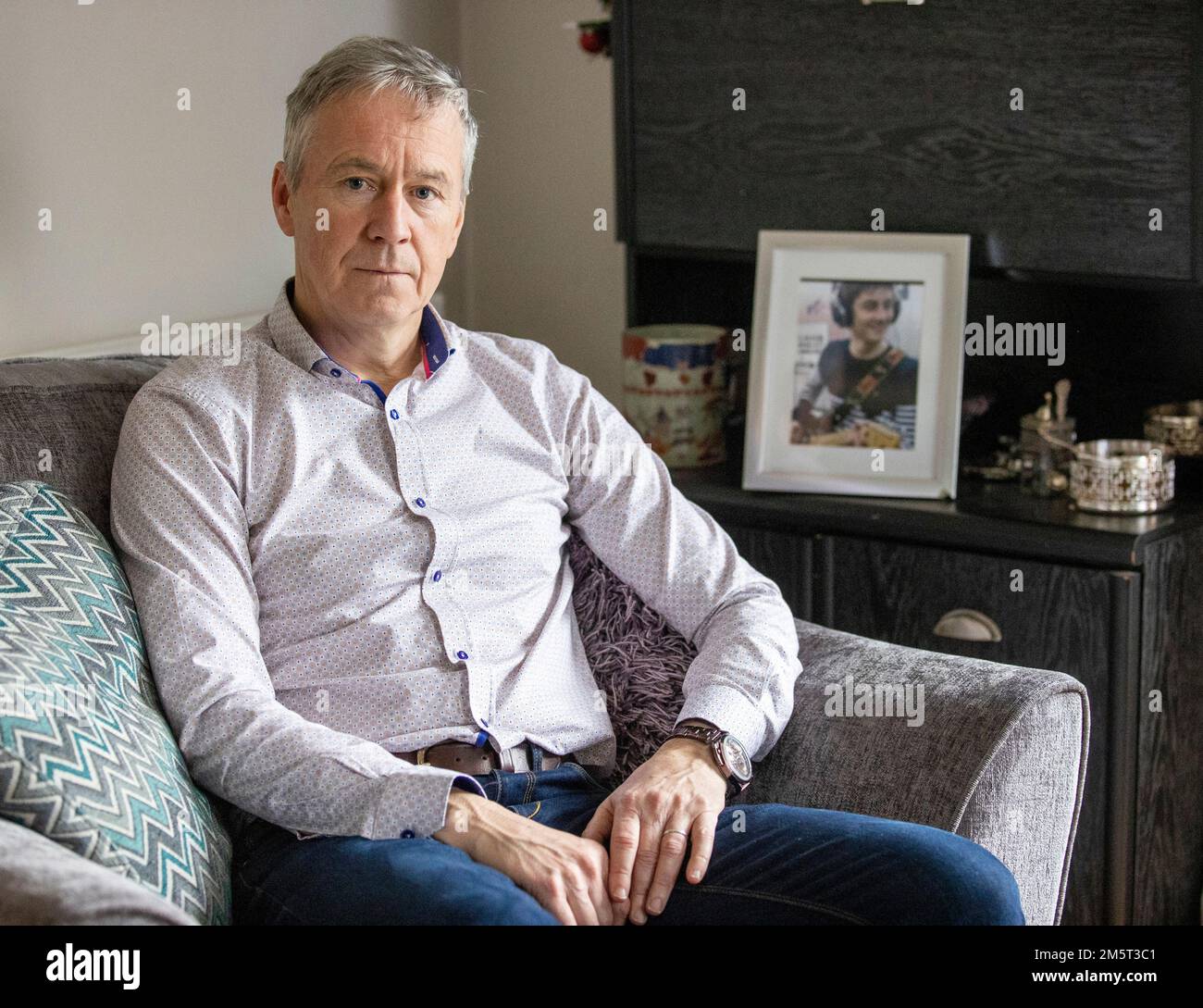 Peter Dolan, sitting beside a picture of his son Enda Dolan, at his ...
