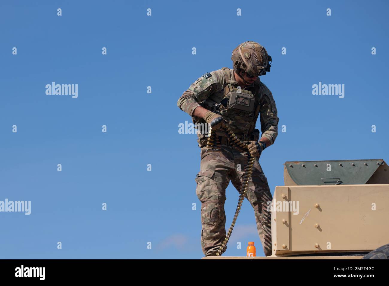 A member of Task Force Wolfhound loads an M2 Machine Gun, at Arta Range ...