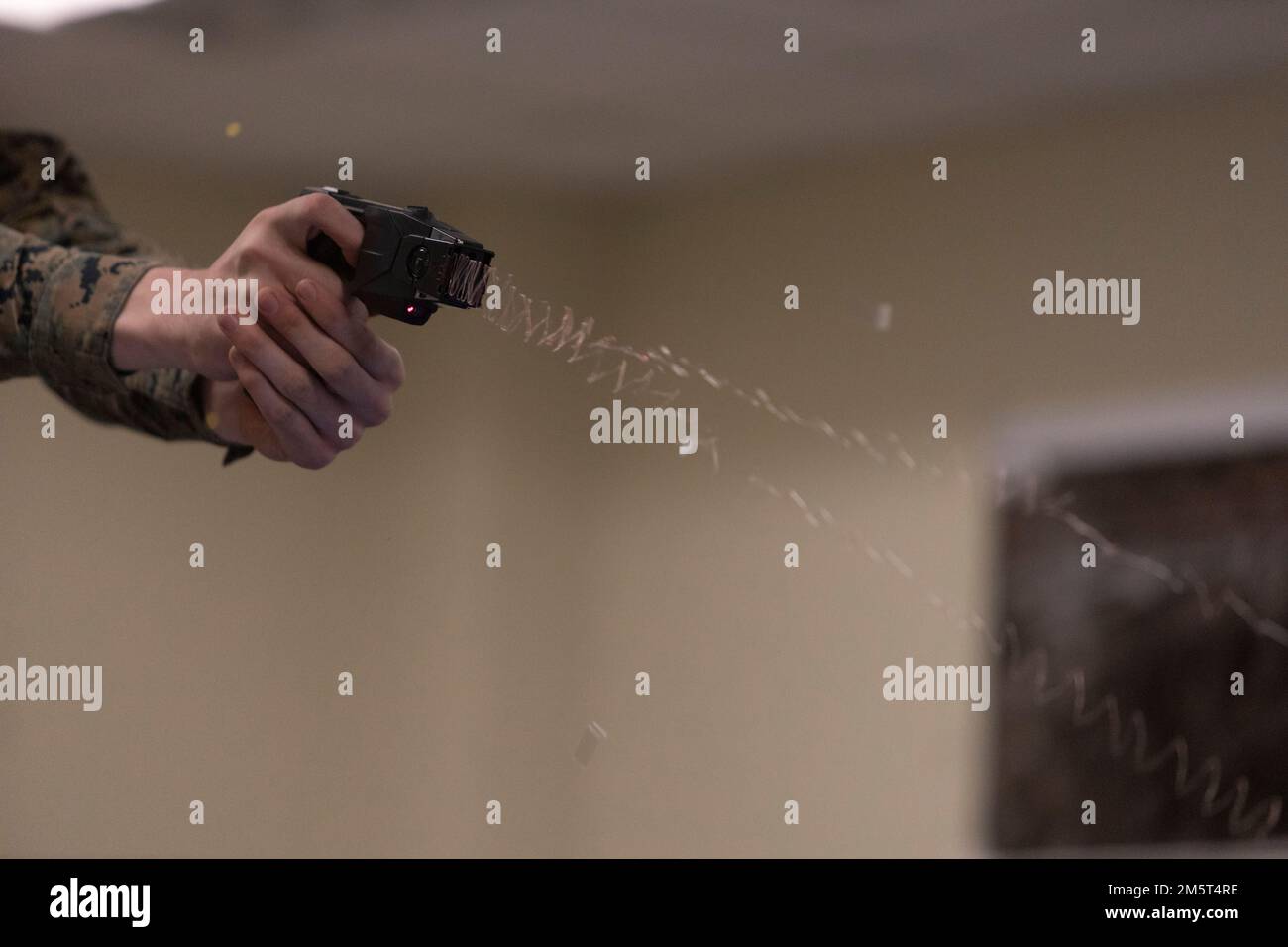 U.S. Marine Corps Cpl. Mason Rupe, a military police officer with Camp Mujuk, fires a Taser X26P ...