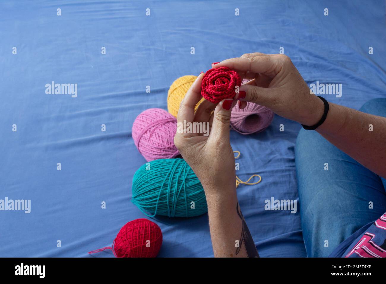 Goiania, Goiás, Brazil – December 30, 2022: A woman sitting on a bed ...