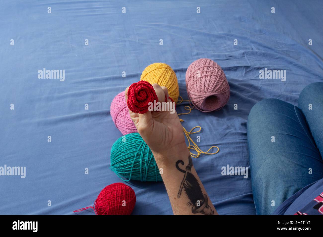 Goiania, Goiás, Brazil – December 30, 2022: A woman sitting on a bed ...
