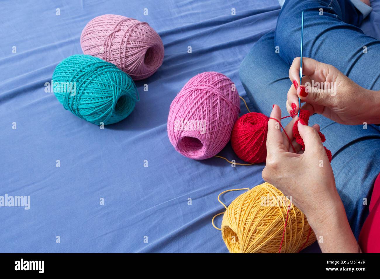 Goiania, Goiás, Brazil – December 30, 2022: A woman sitting on a bed ...