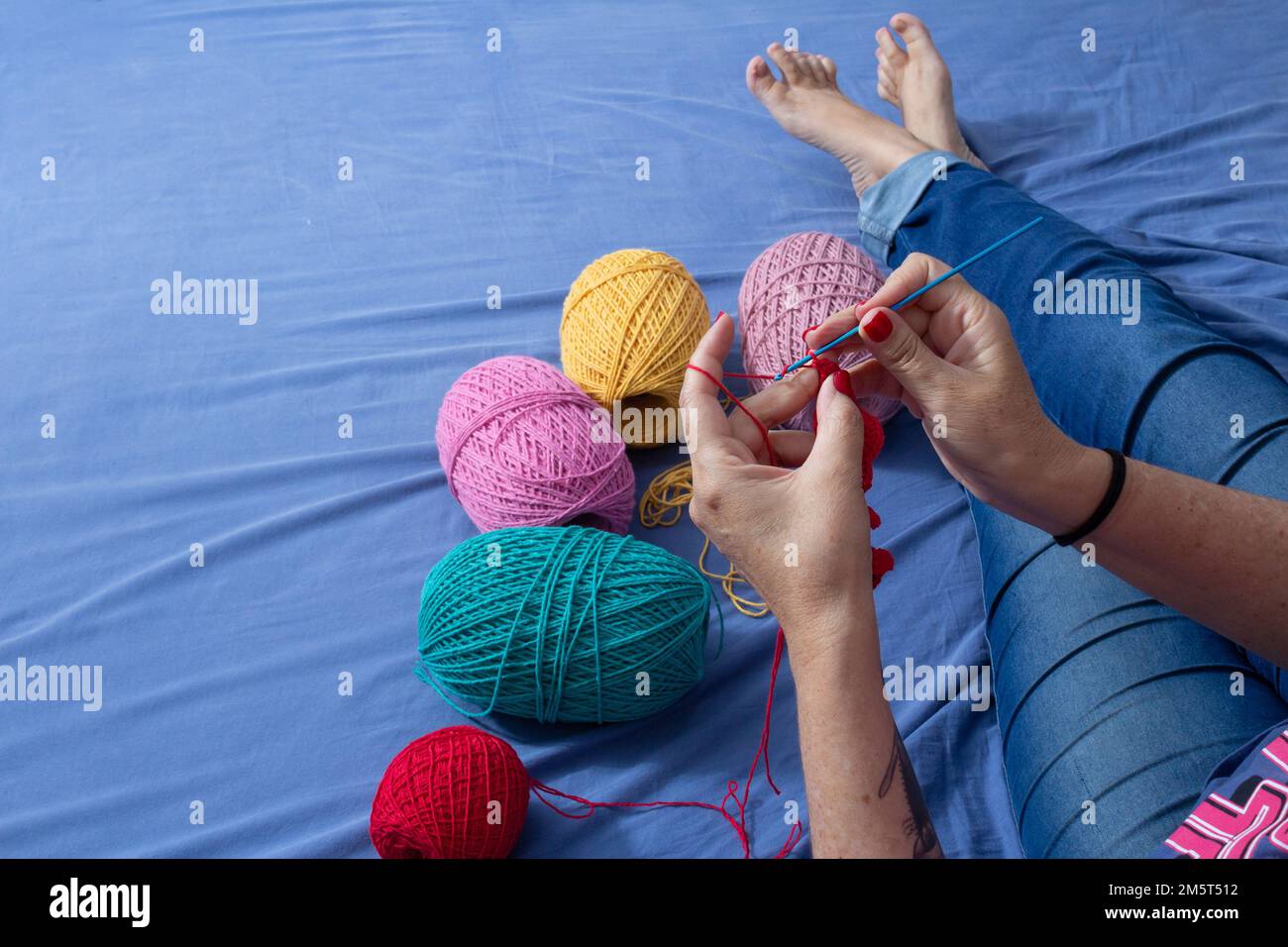 Goiania, Goiás, Brazil – December 30, 2022: A woman sitting on a bed ...