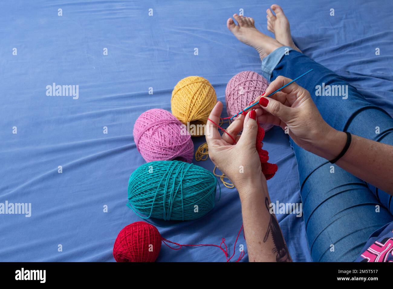 Goiania, Goiás, Brazil – December 30, 2022: A woman sitting on a bed ...