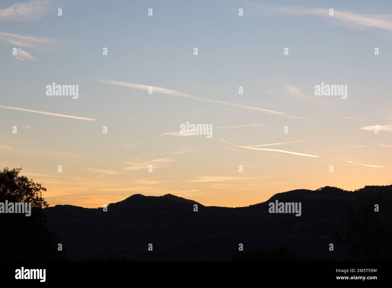 sky streaked by aircraft trails at dusk in the autumn season Stock ...