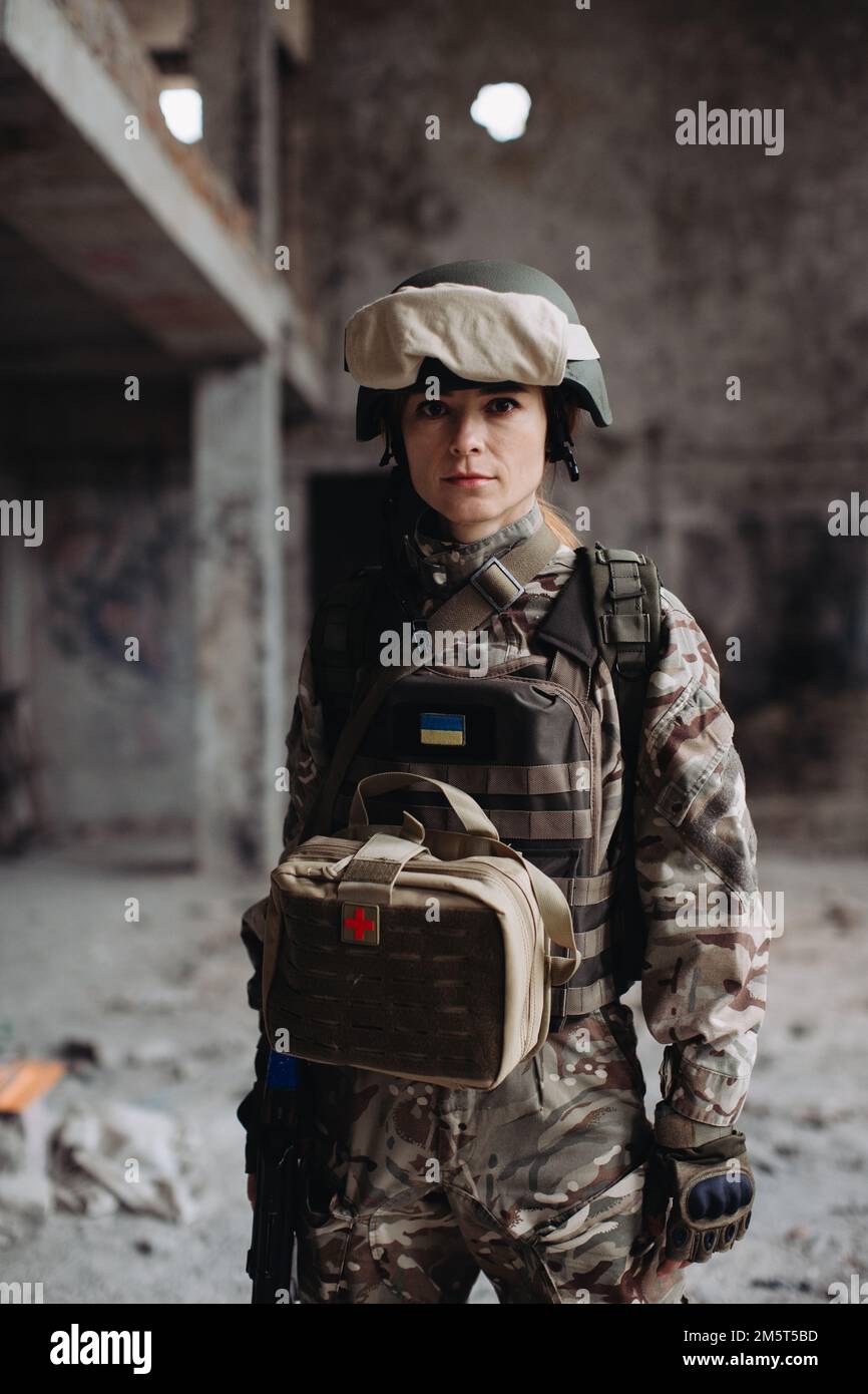 Portrait of a military woman in a destroyed building. Ukrainian woman ...