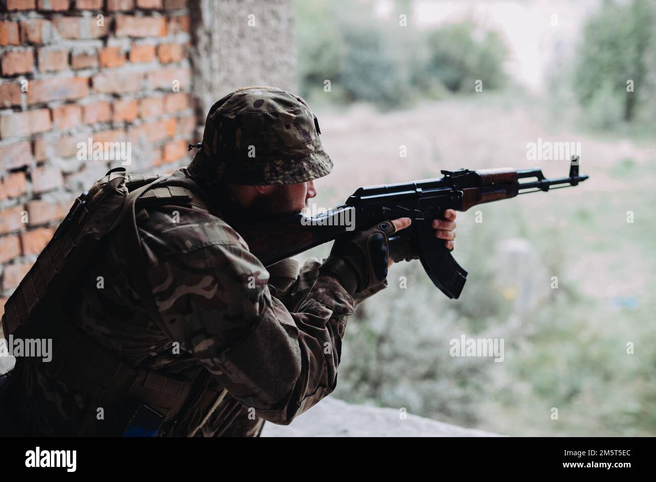 Soldier in war, with weapons in his hands, aim at the enemy Stock Photo ...