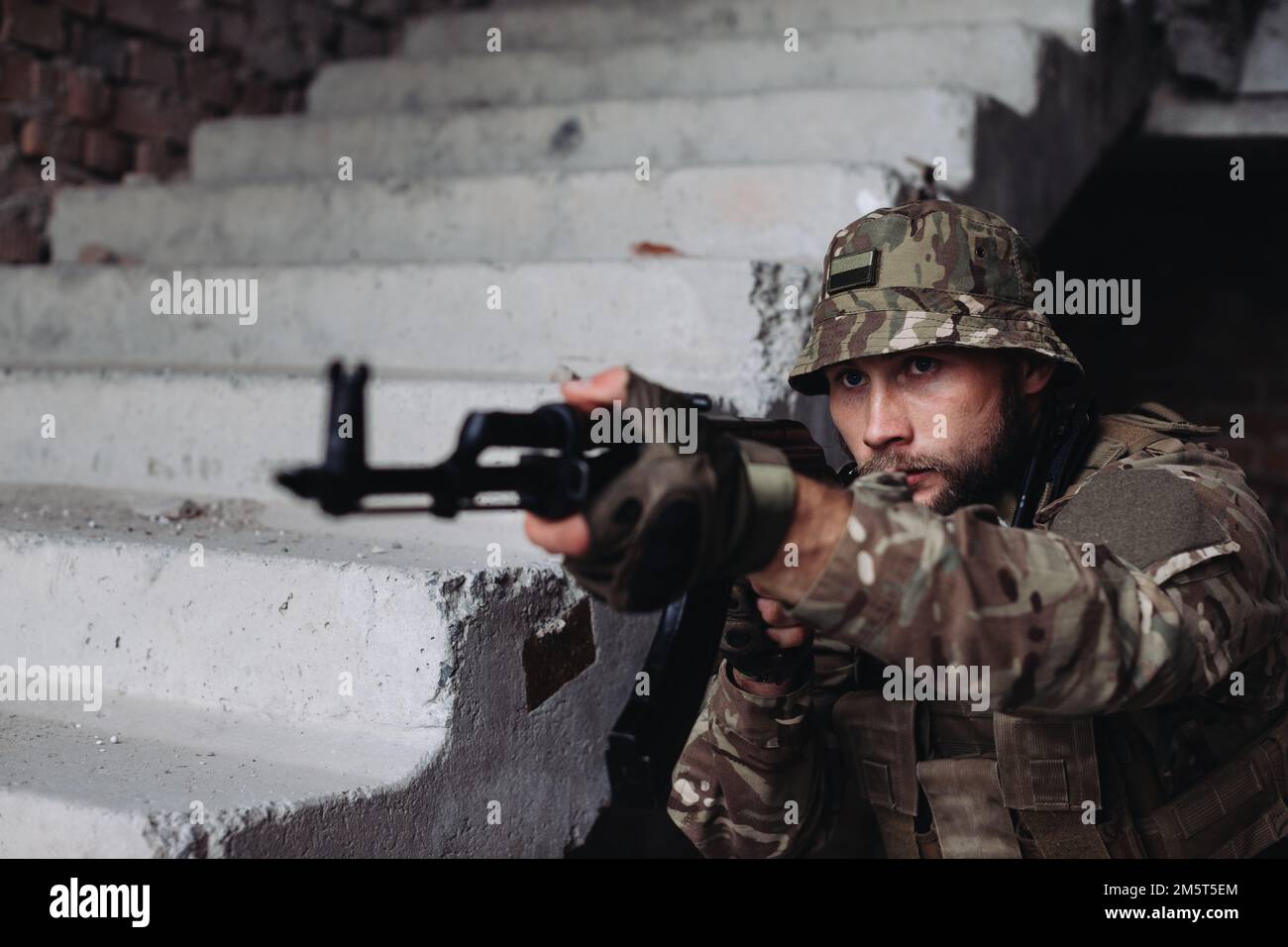 Soldier in war, with weapons in his hands, aim at the enemy Stock Photo ...