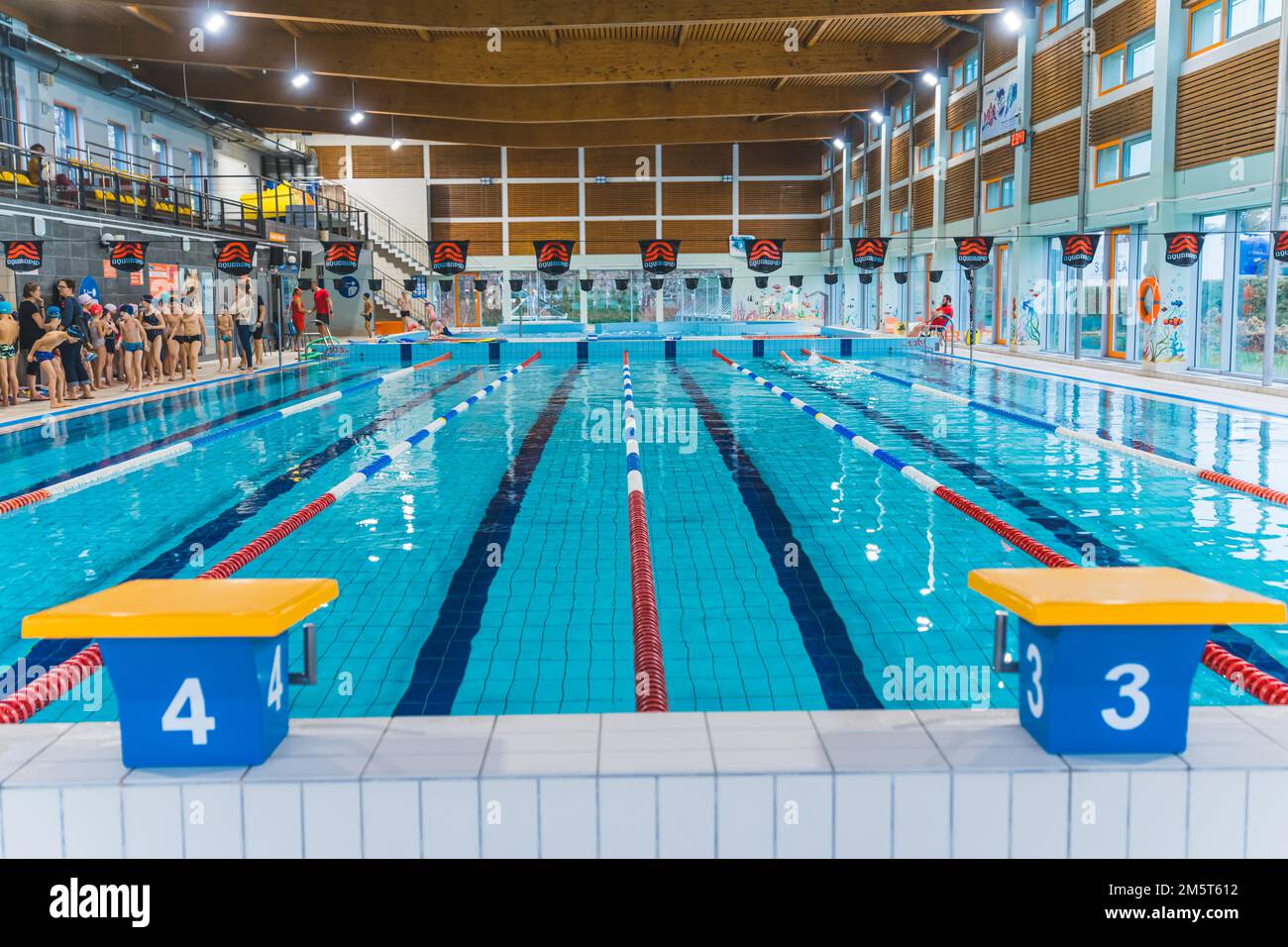 Indoor public swimming pool. Platforms for diving. No people swimming ...