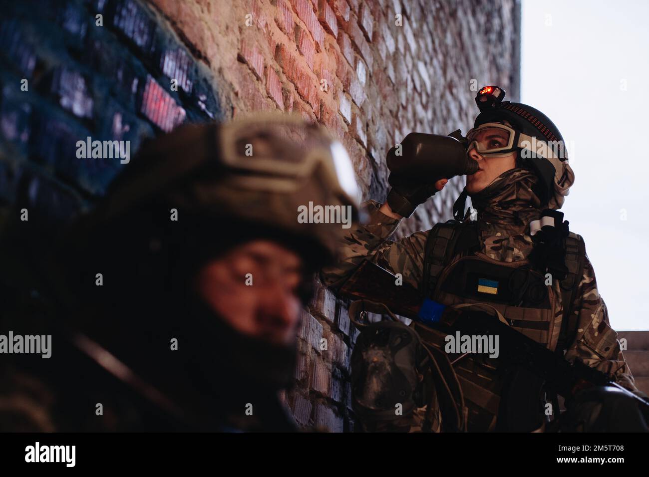 A female soldier drinks water while resting. Ukrainian Military in the ...