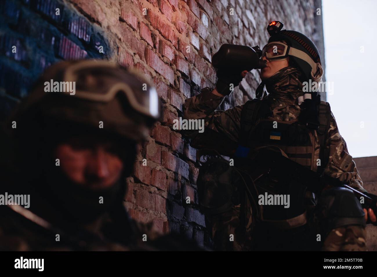 A female soldier drinks water while resting. Ukrainian Military in the ...
