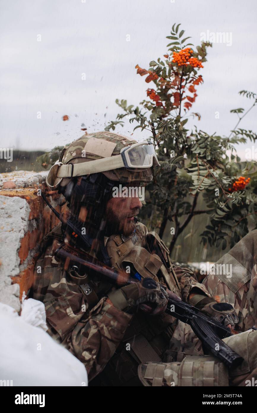 A Ukrainian defender during enemy artillery fire on the front line. War ...