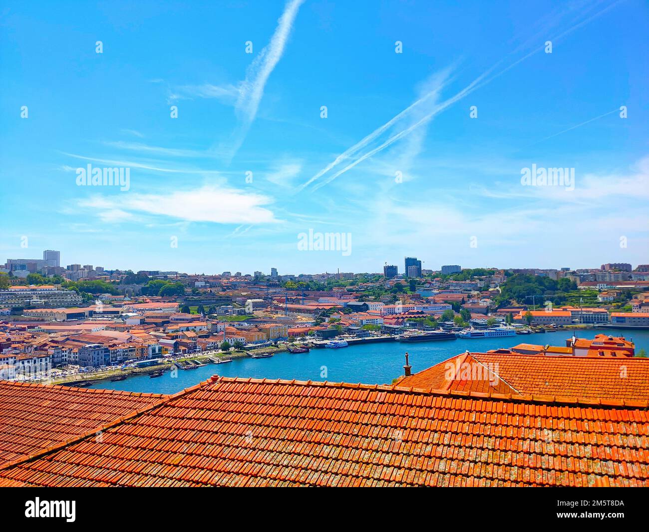 Porto red tiled rooftops, cityscape with Douro river in bright sunshine ...
