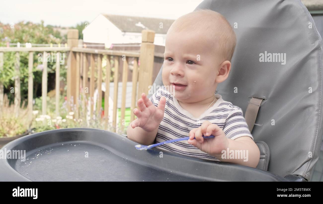 Woman feeding Tired child with spoon. Mom feed crying Sad baby Boy with ...