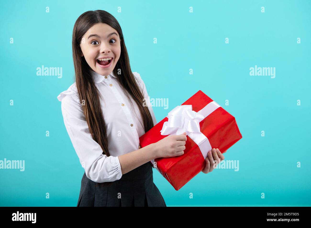 Child with gift present box on isolated studio background. Gifting for ...