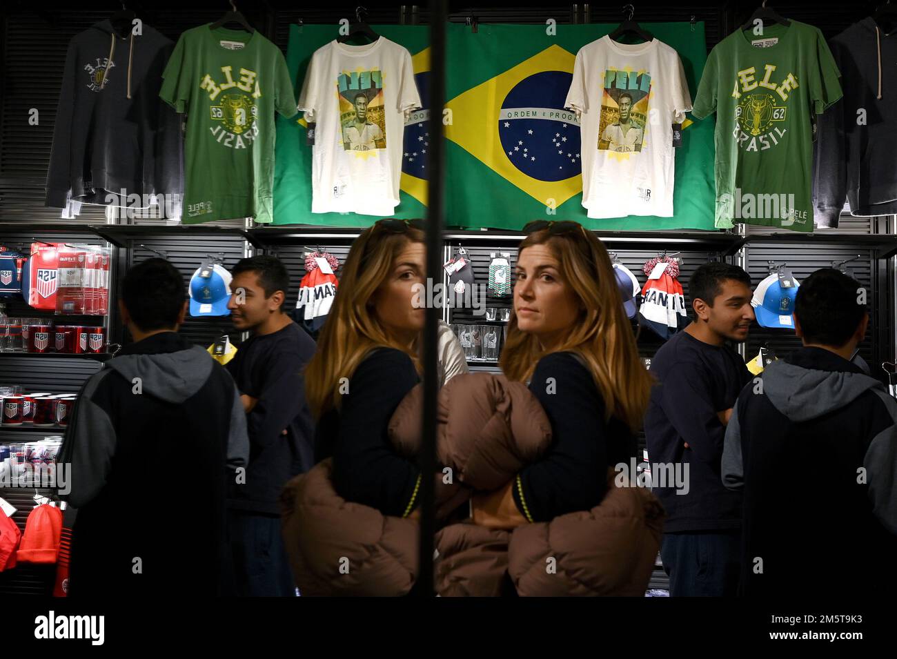 New York, USA. 30th Dec, 2022. Reflected in a mirror, shirts bearing ...