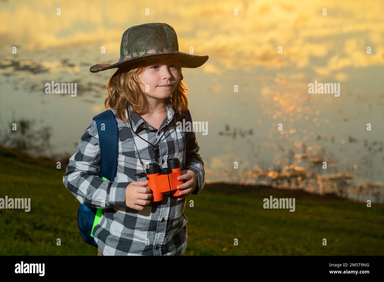Little child with backpack and binoculars. Imagination or exploration ...