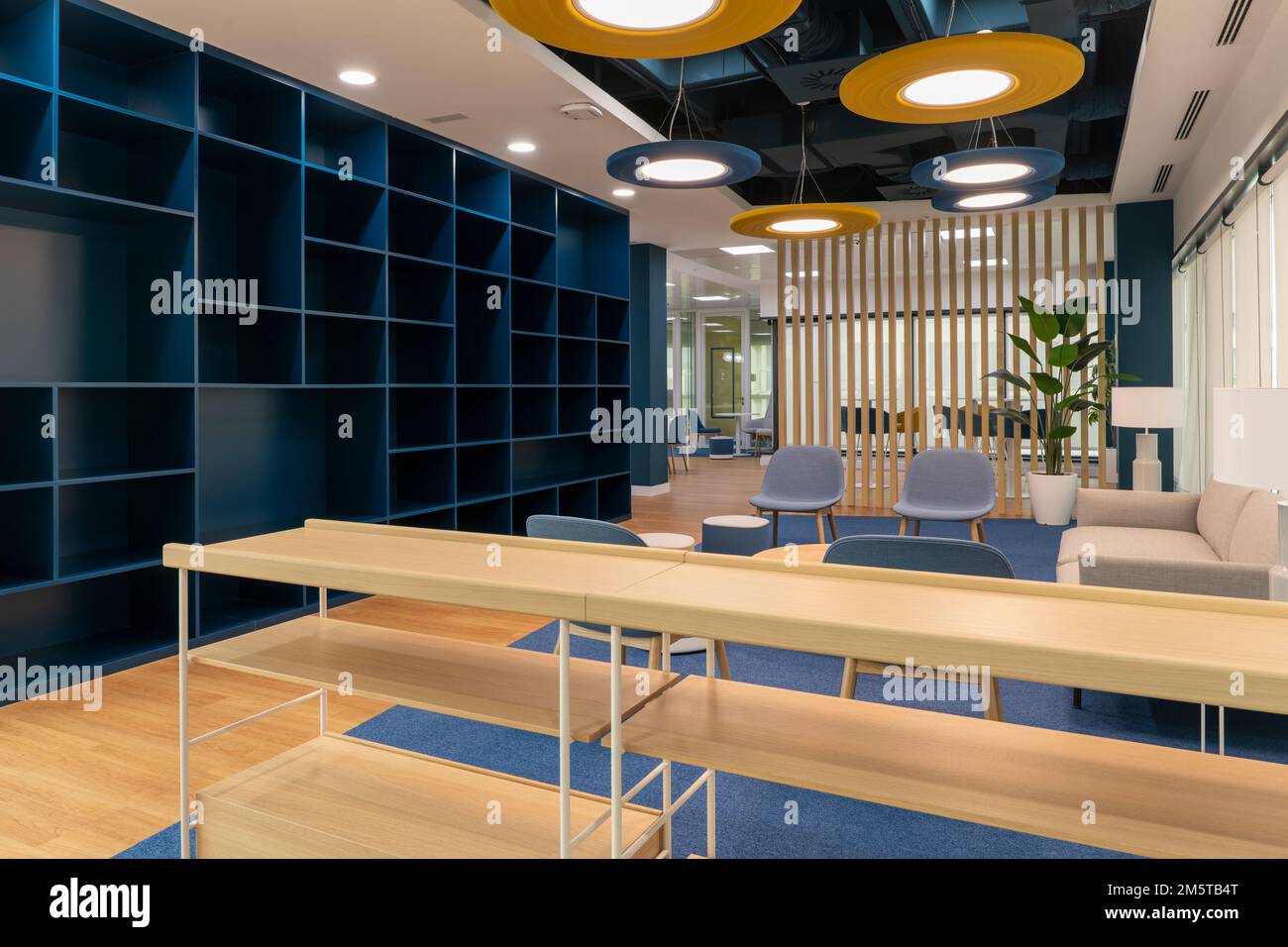 Rest and waiting area in colorful coworking offices with chairs, sofas ...