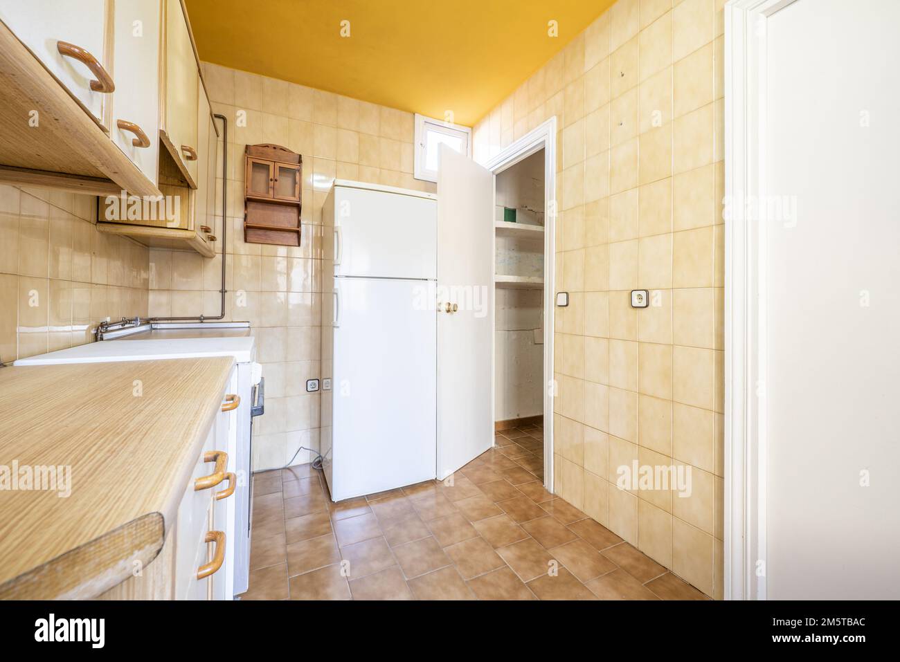 Old kitchen with similar wooden worktop, white furniture and loose ...